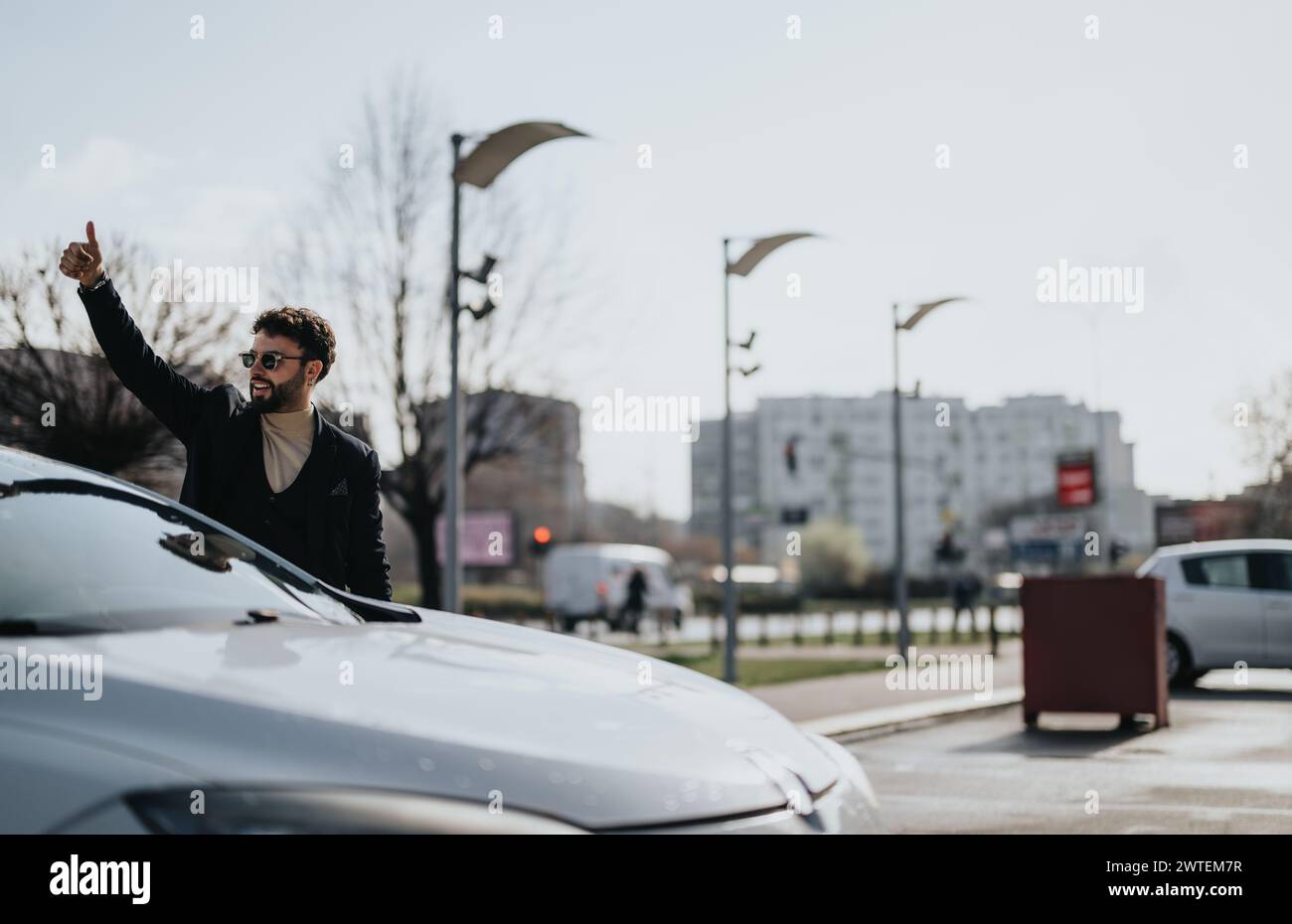 Man hailing a taxi on a sunny day in the city, high resolution image Stock Photo - Alamy
