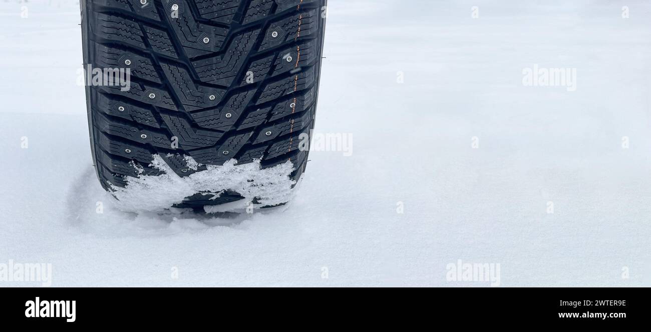 Winter tires with spikes in the snow Stock Photo - Alamy