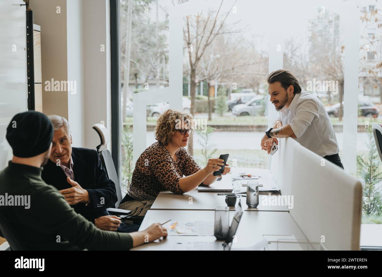 Multi generational group of enthusiastic entrepreneurs collaborating on ...