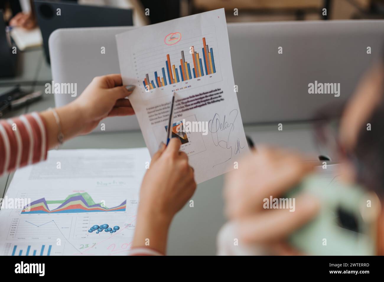 People discussing graph charts. Close up. Cropped photo Stock Photo - Alamy