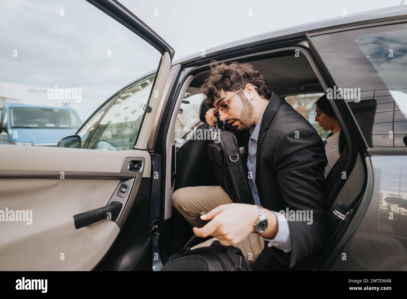 Entrepreneur exiting a car for an outdoor business meeting Stock Photo ...