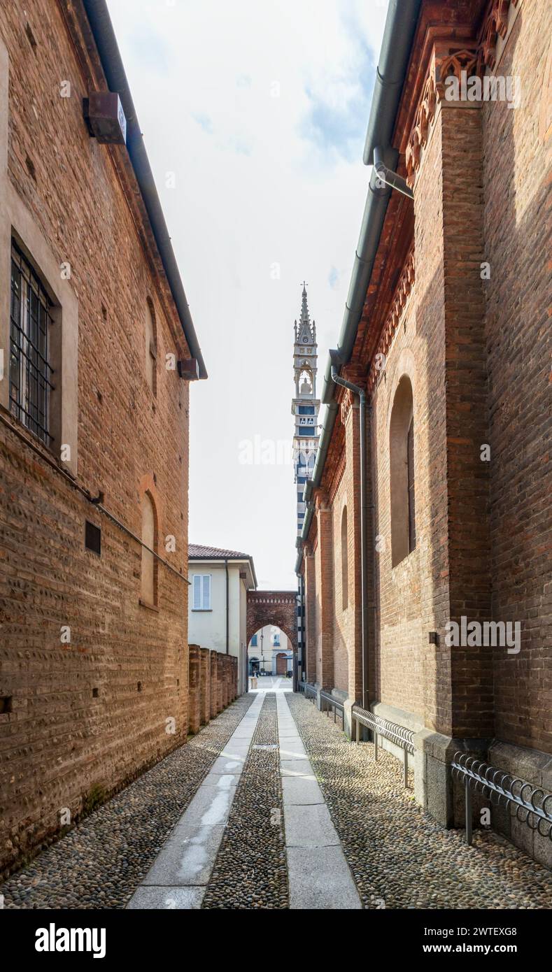 Narrow street with historic buildings in the center of Monza, Italy ...