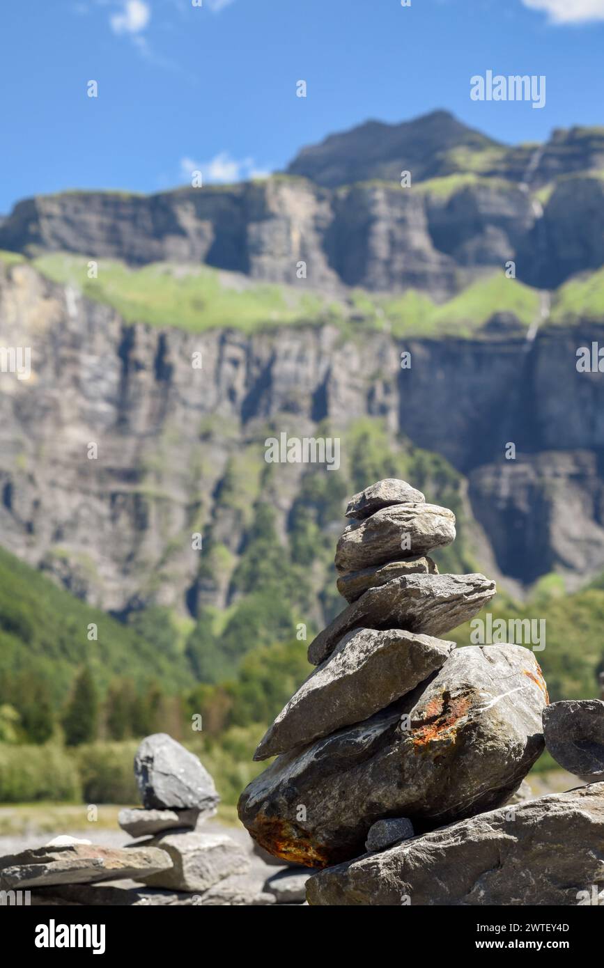 Stack of balancing rocks symbolising peace and mindfulness over a lush ...