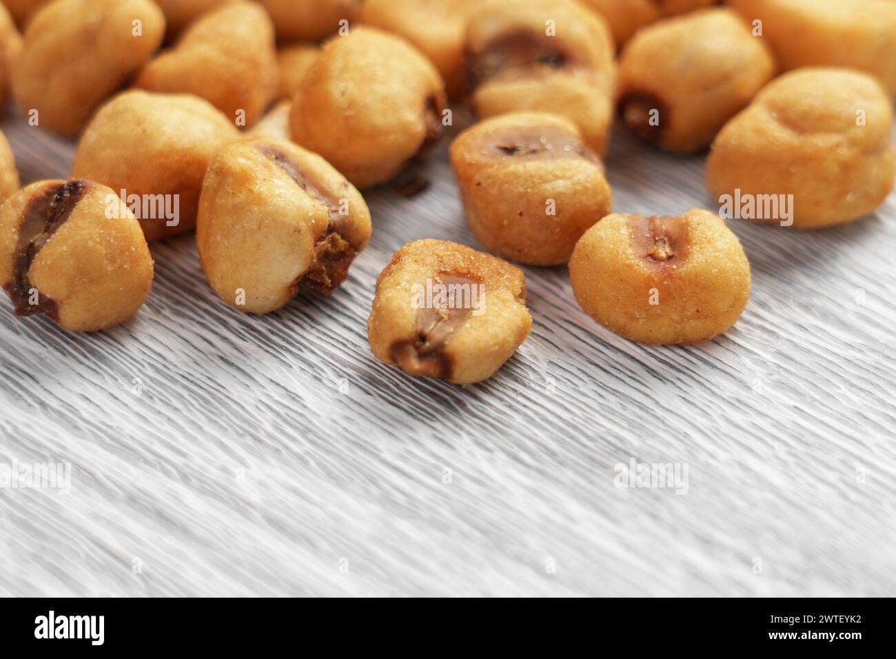 Salted roasted corn snack on a board close up. Whole toasted maize ...