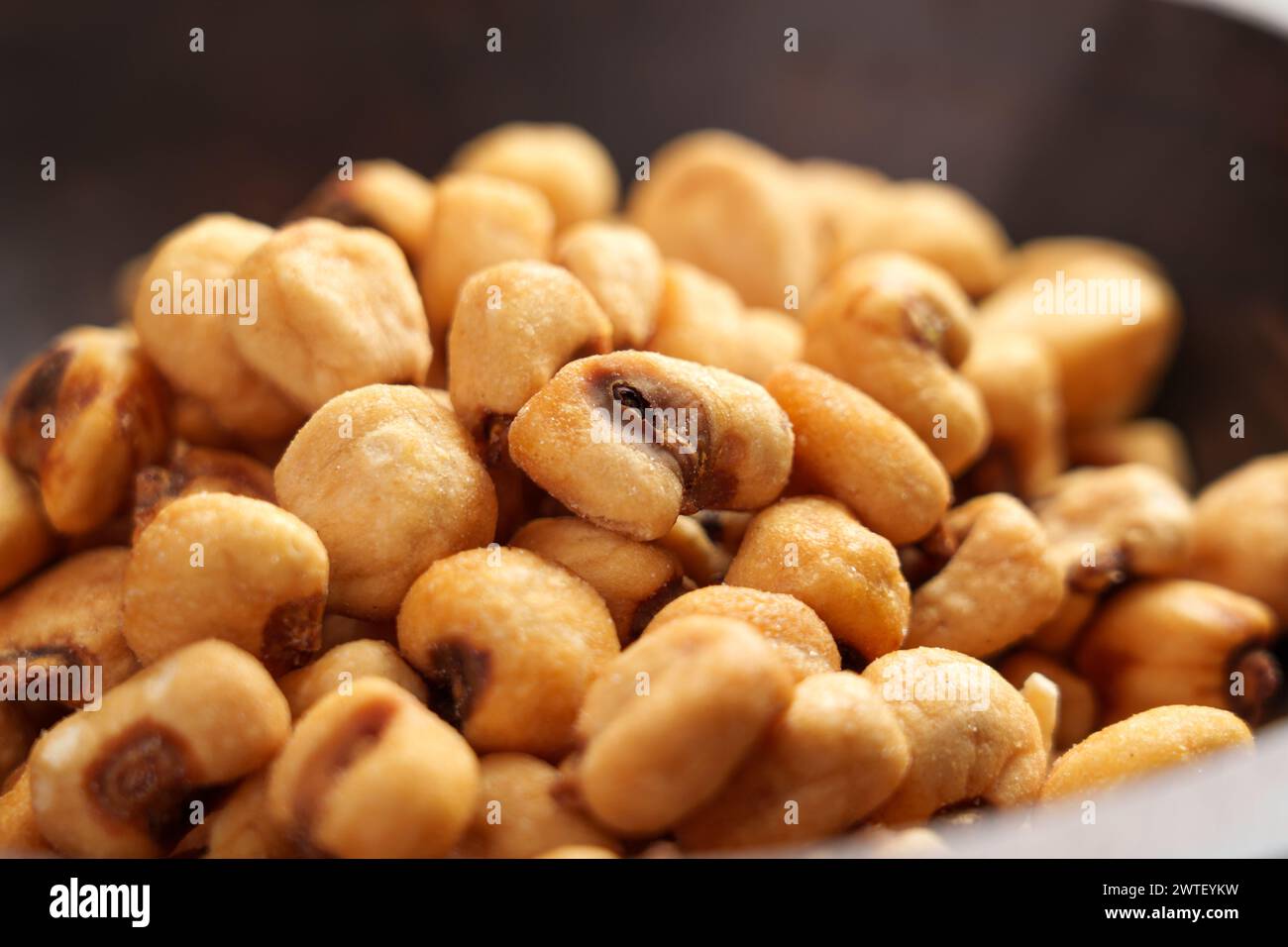 Organic salty roasted dried maize grains in wooden bowl close up. Tasty ...