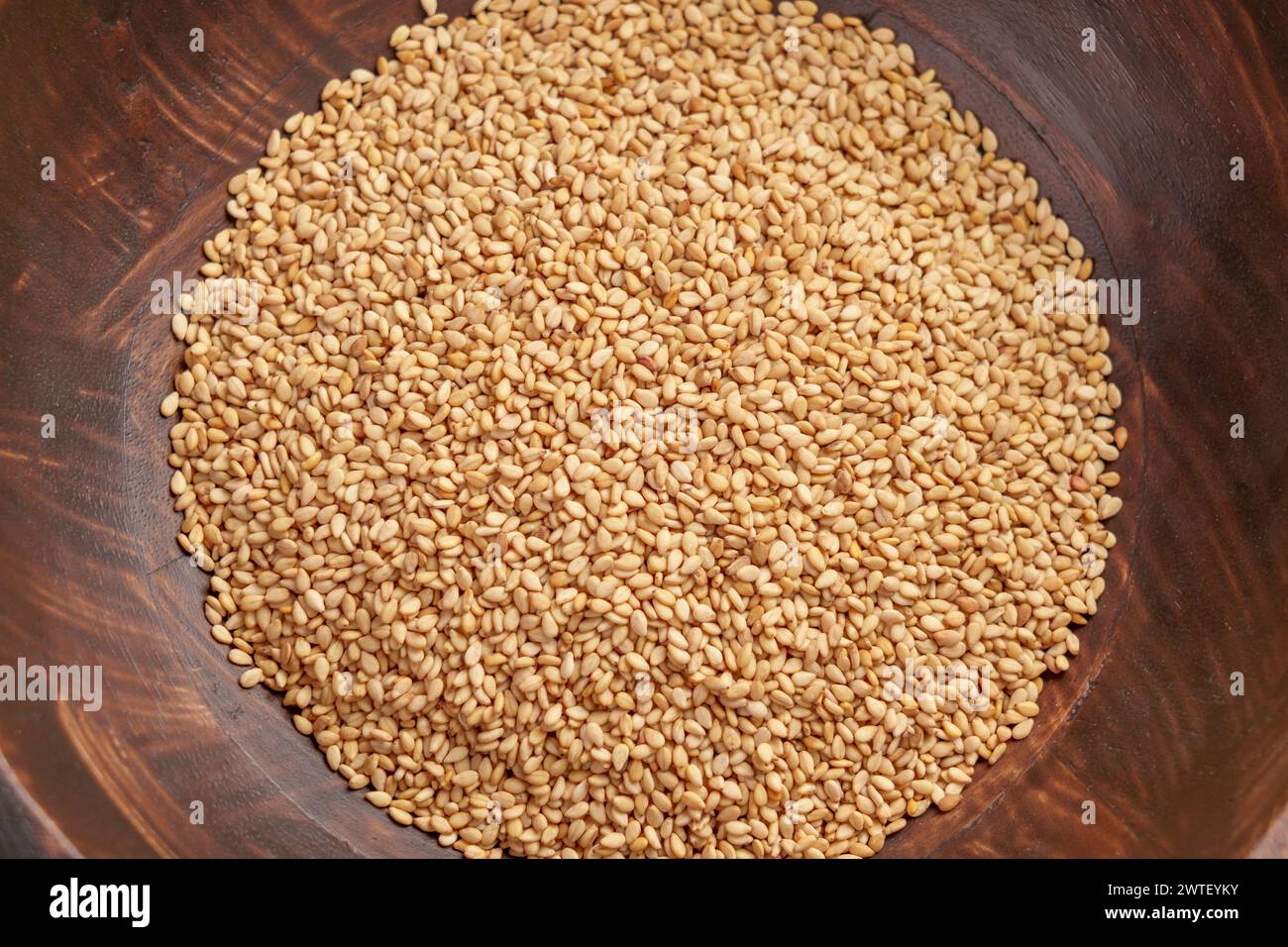 Sesame seeds in a rustic wooden bowl. Traditional Indian Asian spices ...