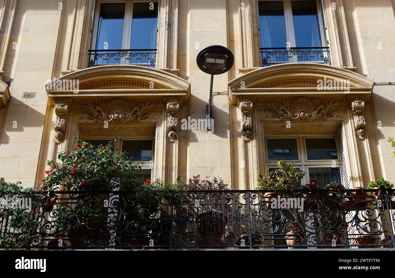The facade of traditional French house with typical balconies and ...