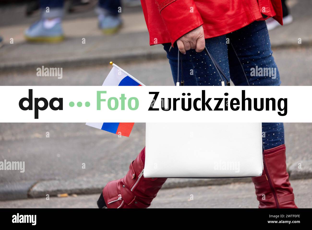 Bonn, Germany. 17th Mar, 2024. A Russian citizen carries a small ...
