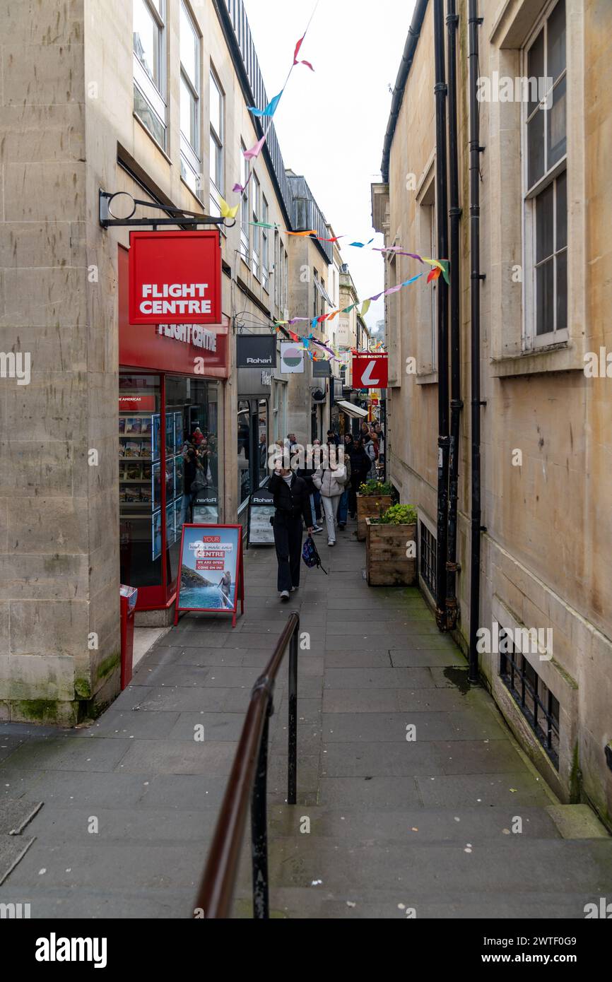 Vibrant city street with flying flags, storefronts, and pedestrians ...