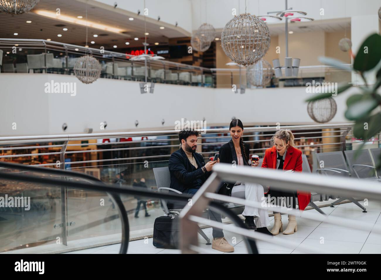 Colleagues enjoying coffee break in a modern office atrium Stock Photo ...