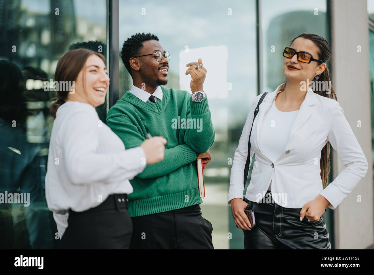 Young startup colleagues brainstorming at an outdoor urban meeting ...
