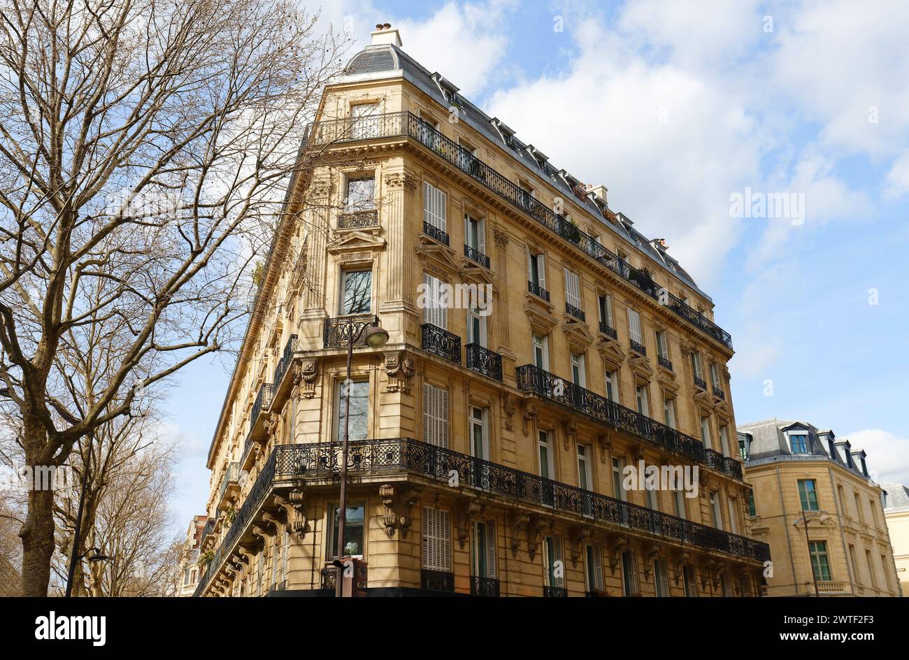 The facade of traditional French house with typical balconies and ...