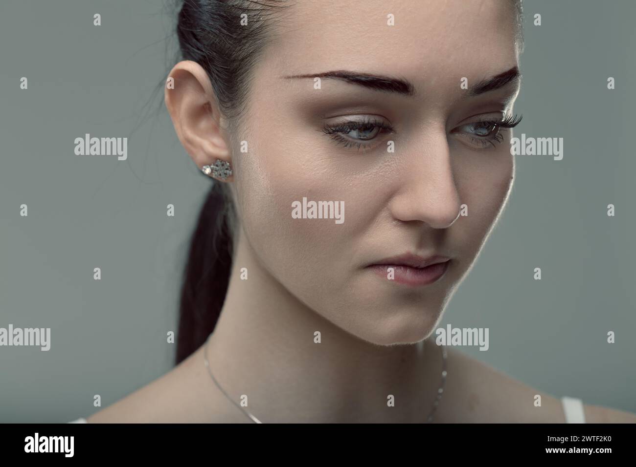 The soft light accentuates her contemplative mood and the nuances of ...