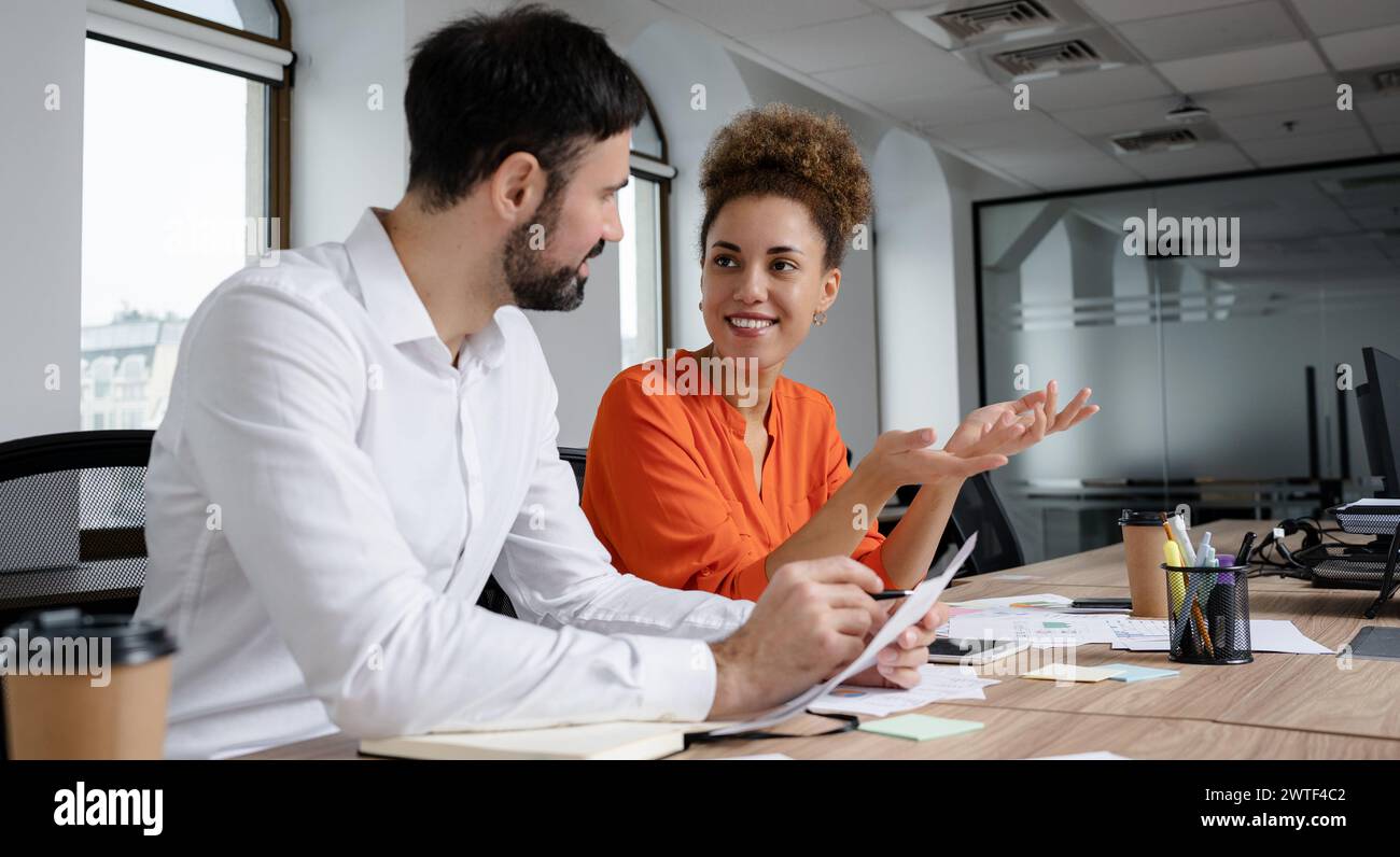 Young busy African business woman executive working on laptop making ...