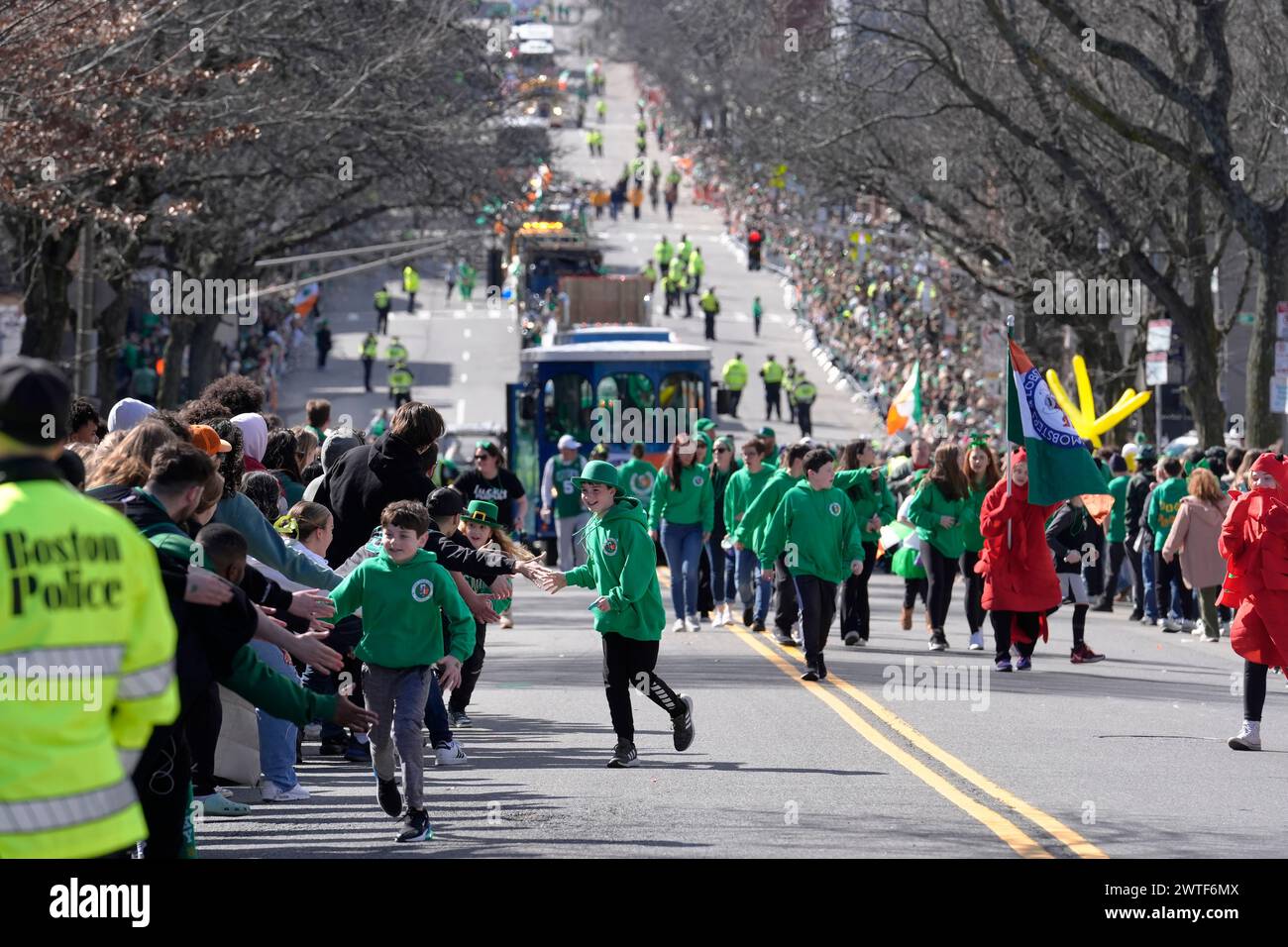 Children greet spectators while marching in the St. Patrick's Day ...