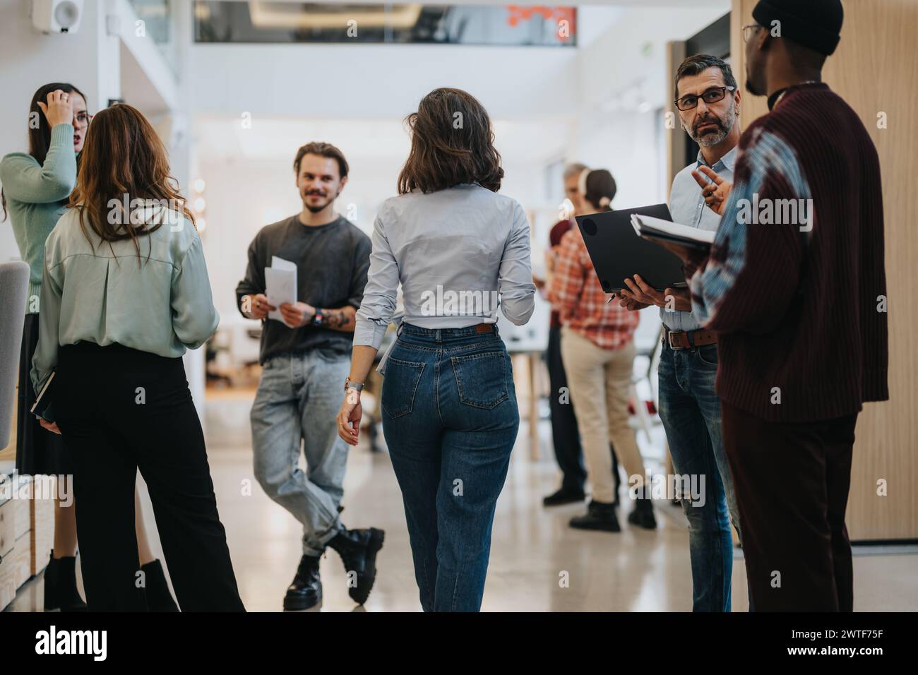 A candid scene of a group of multiethnic colleagues having a casual ...