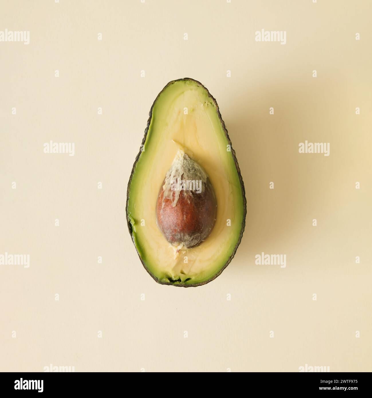 Avocado with copy space on beige background. Sliced fresh ingredient ...