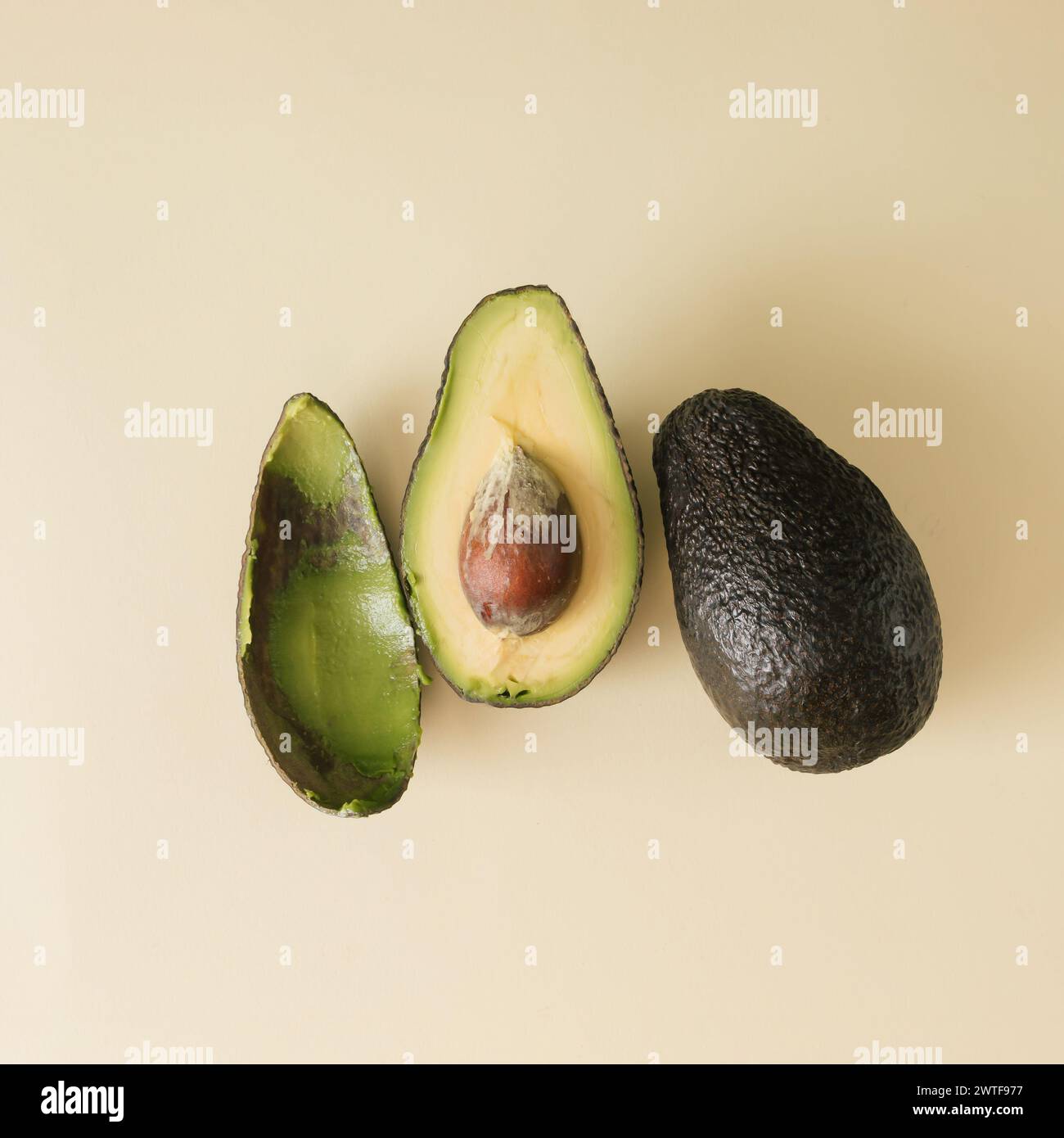 Avocado with copy space on beige background. Sliced fresh ingredient ...
