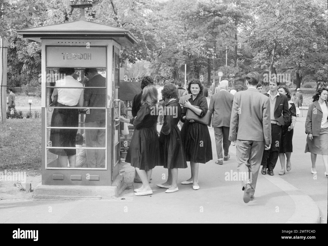 Vintage Photography: Young people wait in line to use a telephone booth ...