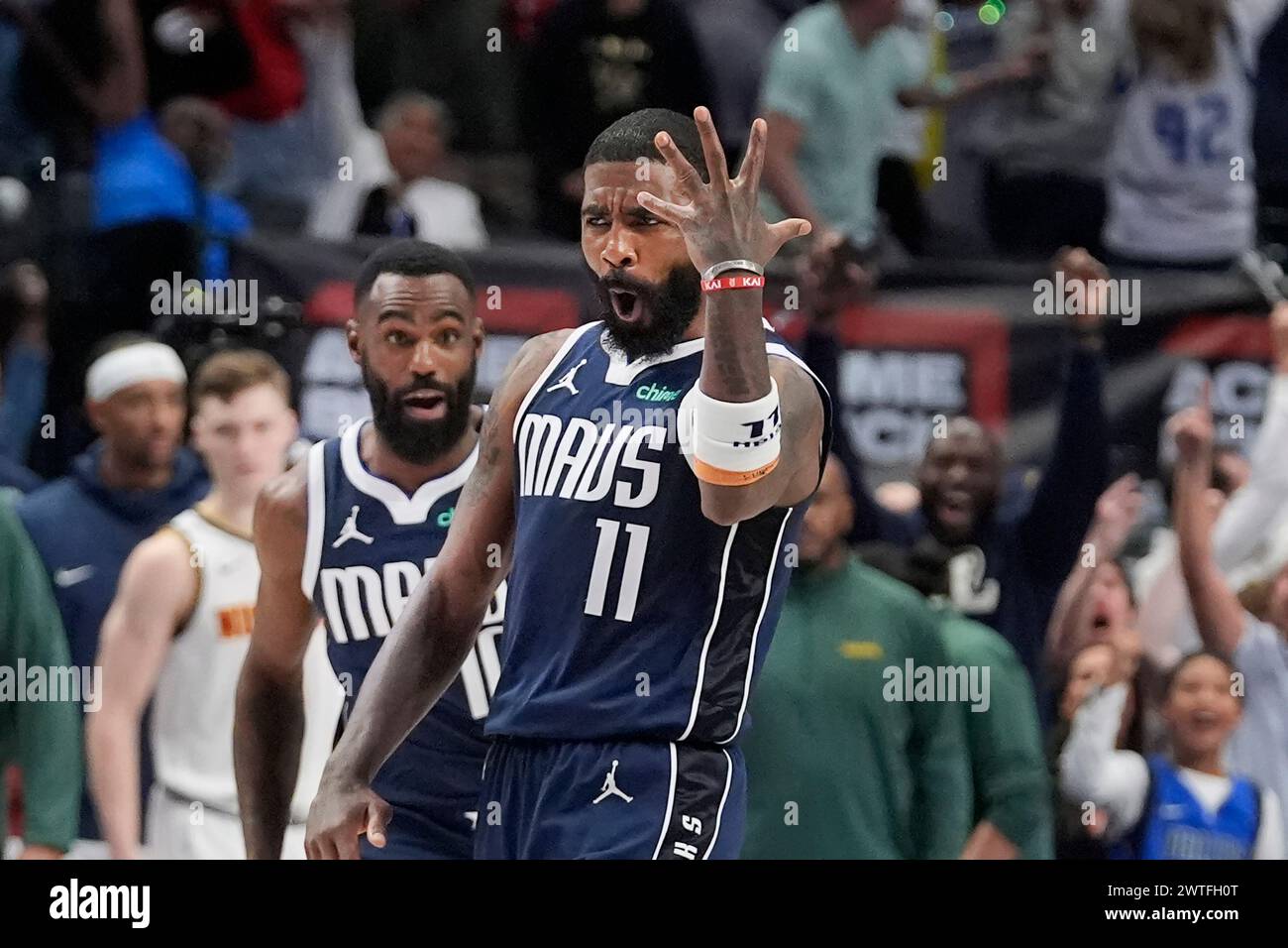 Dallas Mavericks guard Kyrie Irving (11) reacts as teammate Tim Hardaway Jr. runs up after ...
