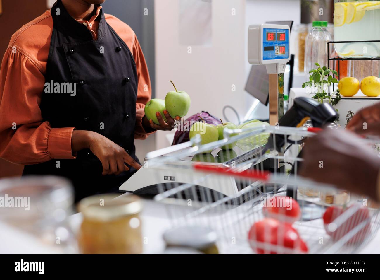 Selective focus on african american female vendor holding green apples ...