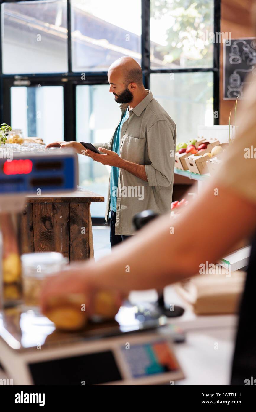 An Arab male customer browsing on the internet while looking at a ...