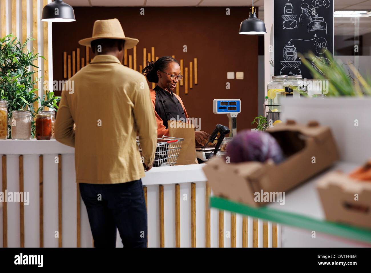 A friendly female cashier with a big smile on her face and a cool ...