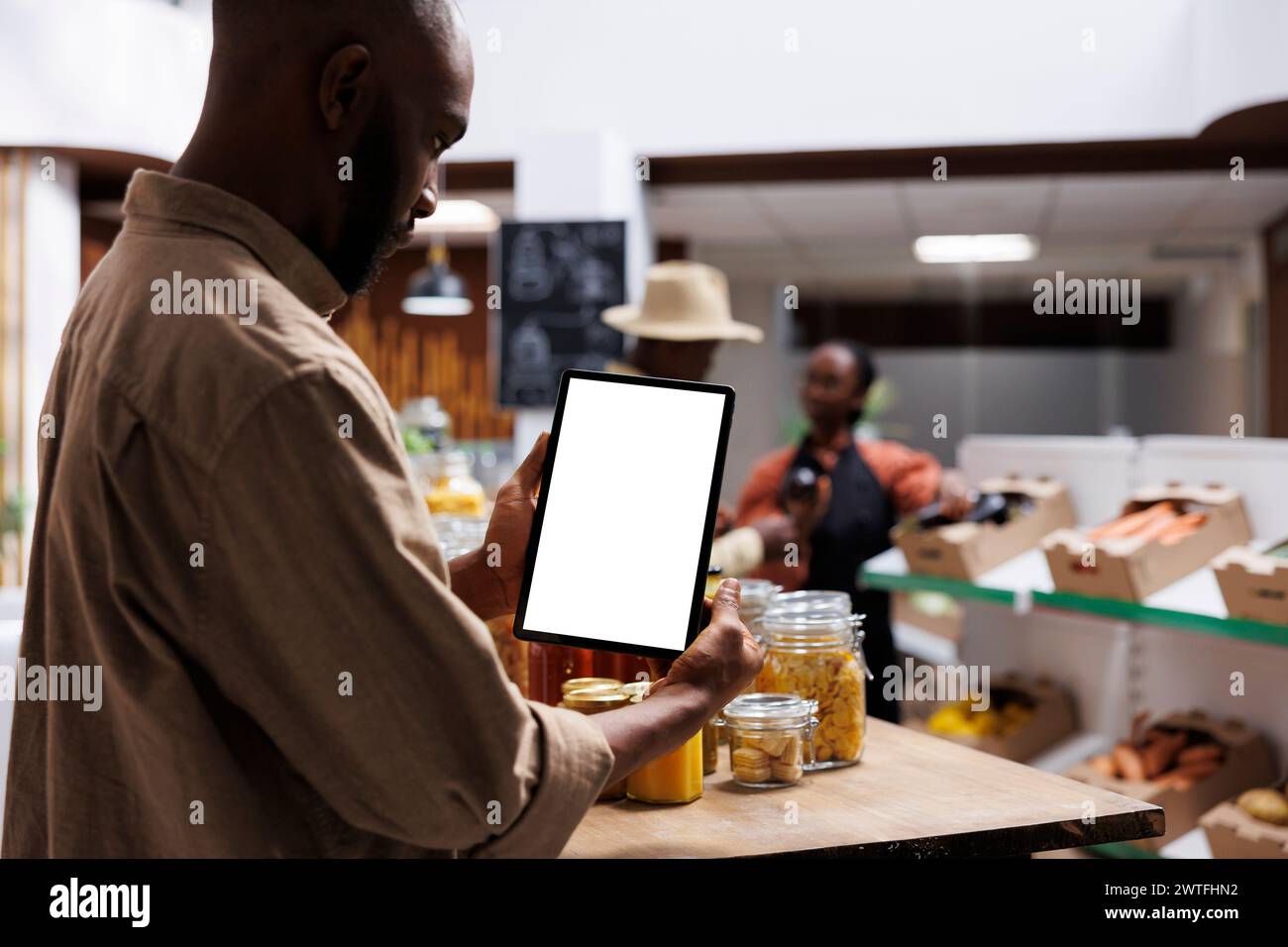 African American guy browses the bio-food items, jars, and foods on ...