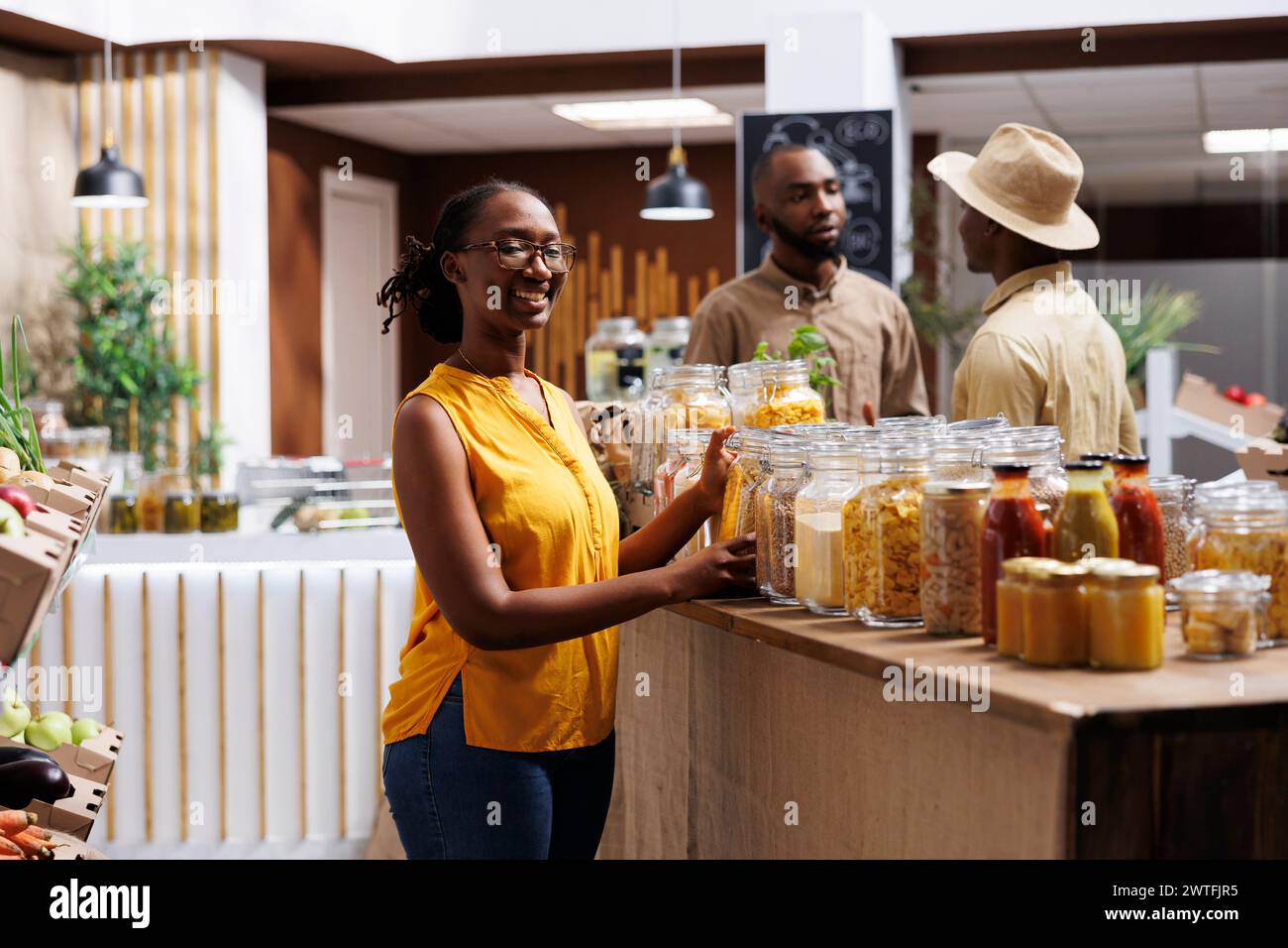 Female customer smiles as she looks at the camera. Sustainable products ...