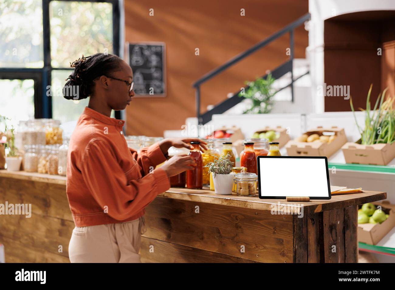 African american female customer browsing in store near a tablet ...