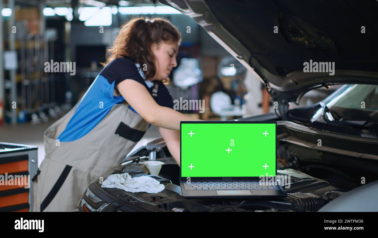 Close up panning shot of chroma key laptop in garage facility sitting ...