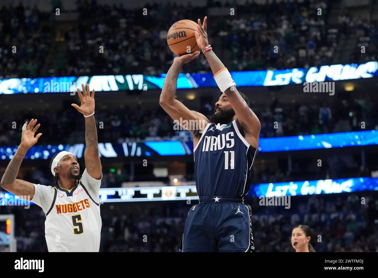 Dallas Mavericks guard Kyrie Irving (11) shoots against Denver Nuggets ...