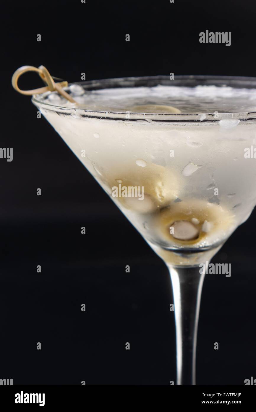 Chilled vodka martini with bleu cheese stuffed olives isolated over a ...