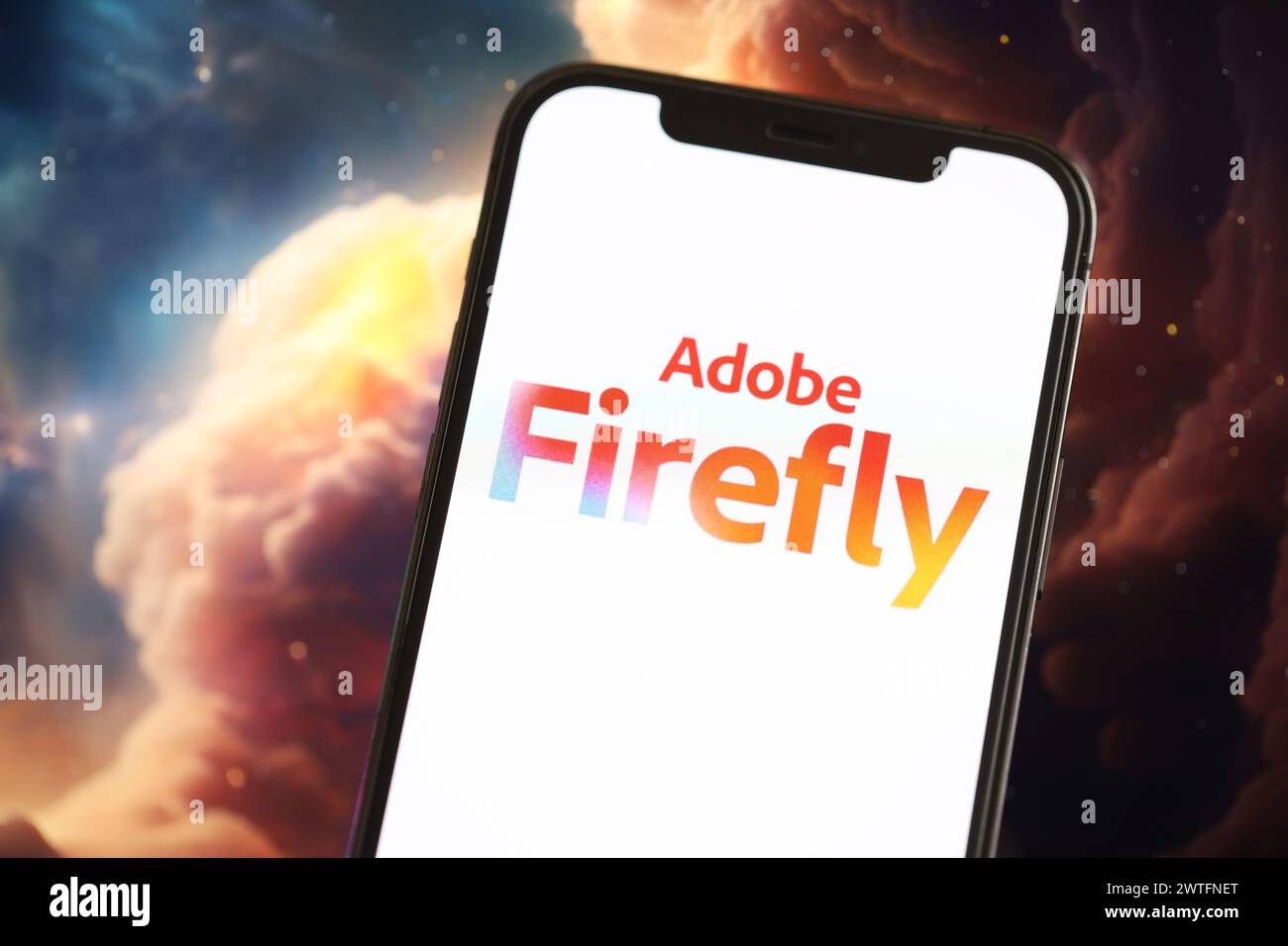 KYIV, UKRAINE - MARCH 17, 2024 Adobe Firefly logo on iPhone display screen with background of ...