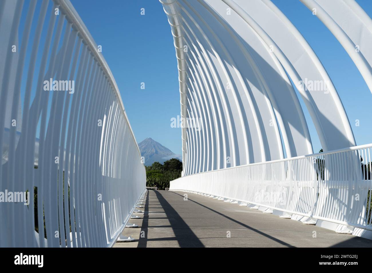 New Plymouth. New Zealand - March 1 2024; Cyclist crossing white steel ...