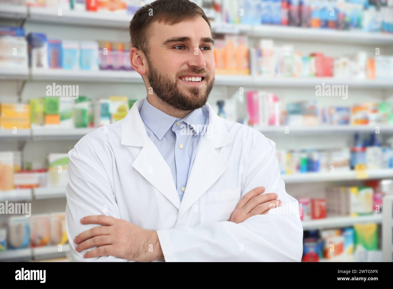 Professional pharmacist with crossed arms in modern drugstore Stock ...