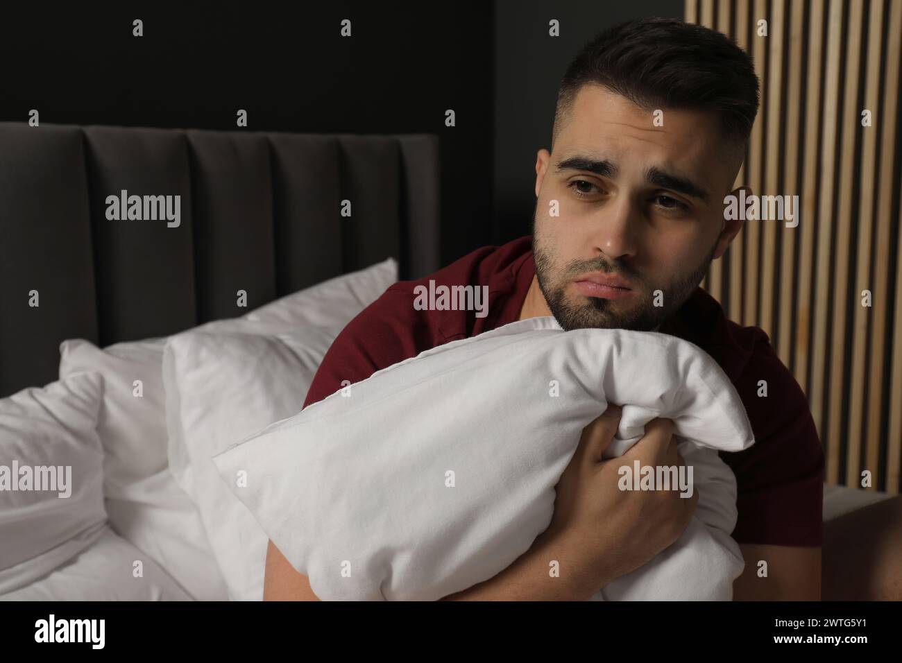 Sad unhappy man hugging pillow hi-res stock photography and images - Alamy