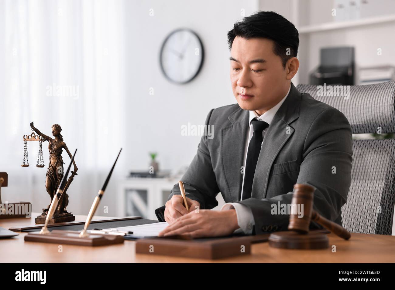 Notary writing notes at wooden table in office Stock Photo - Alamy