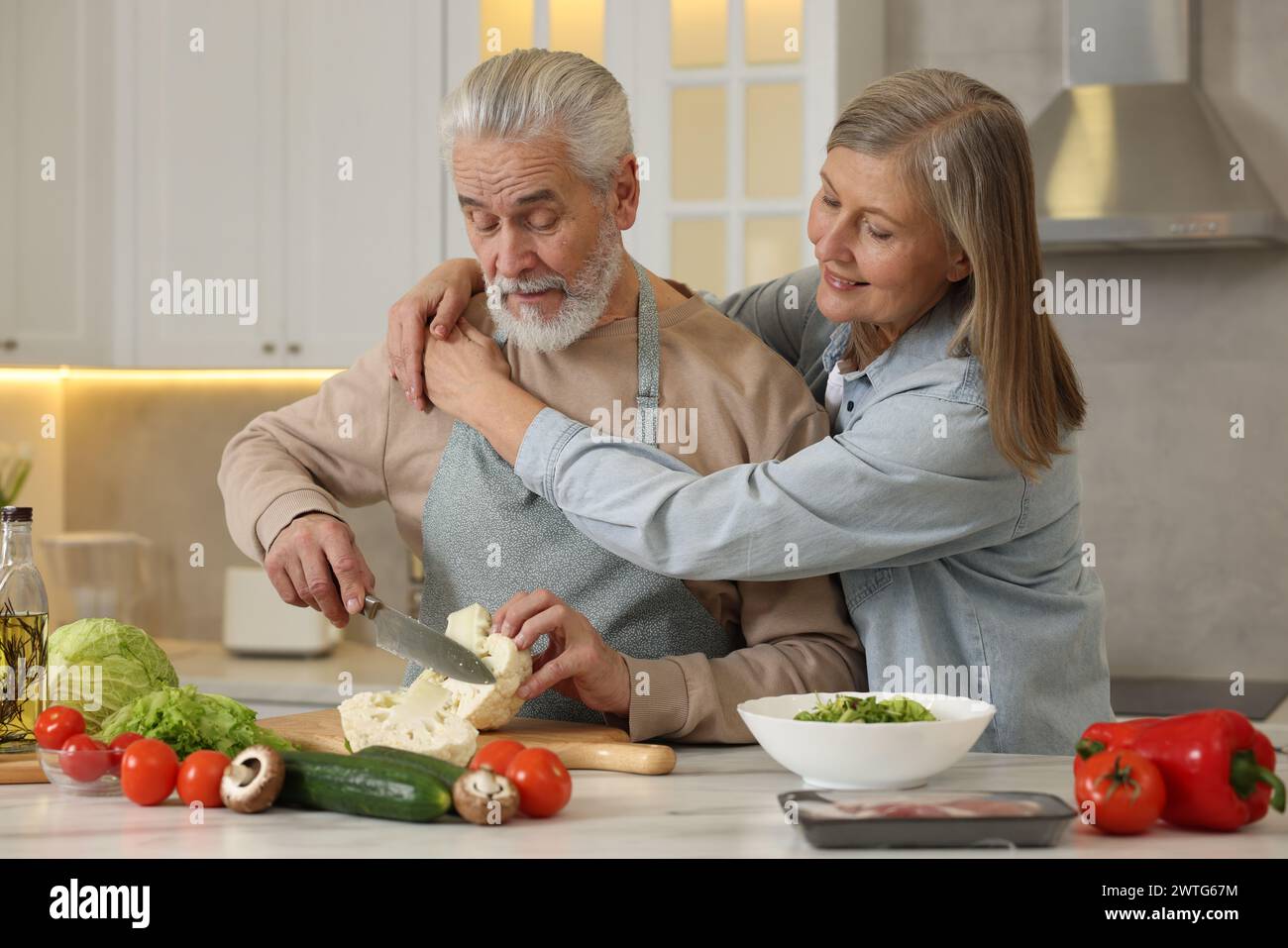 Caucasian elderly couple cooking romantic hi-res stock photography and ...