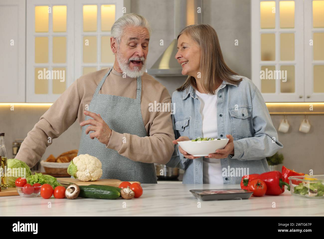 Senior couple cooking together in hi-res stock photography and images ...