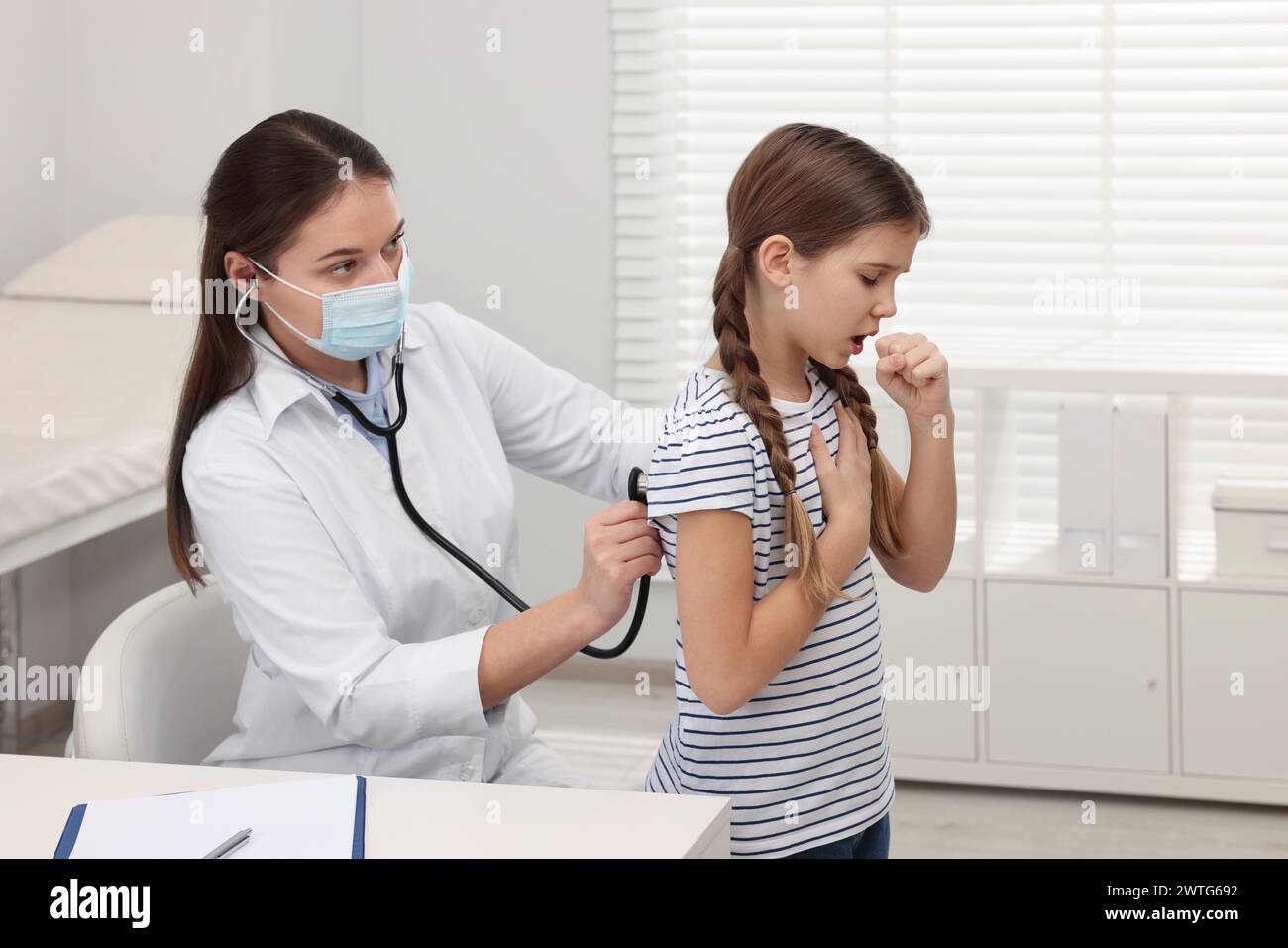 Doctor examining coughing girl hi-res stock photography and images - Alamy