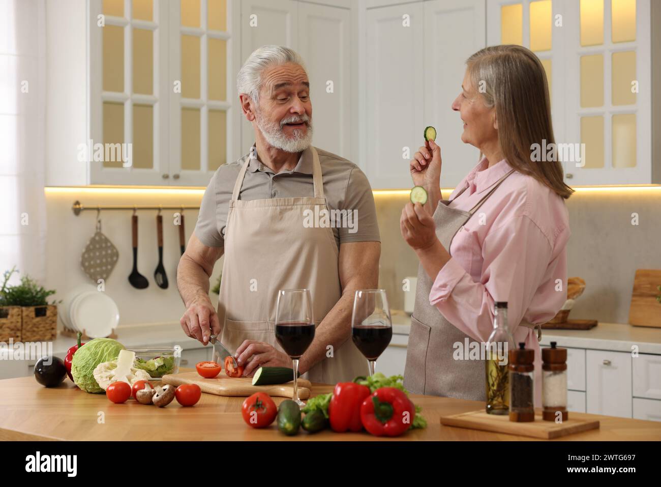 Caucasian elderly couple cooking romantic hi-res stock photography and ...