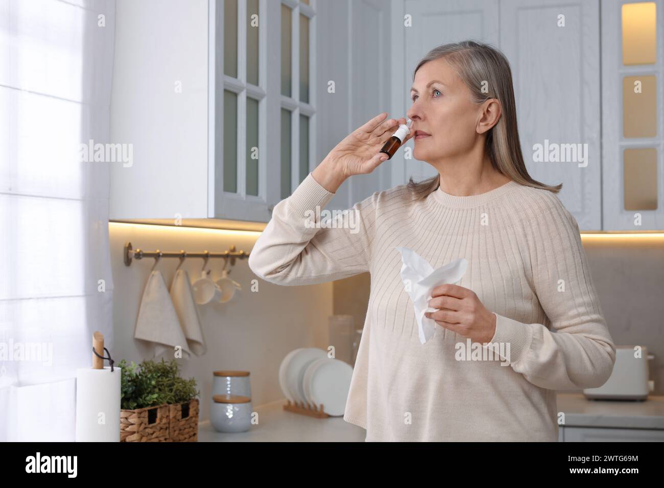 Medical drops. Woman using nasal spray indoors Stock Photo - Alamy