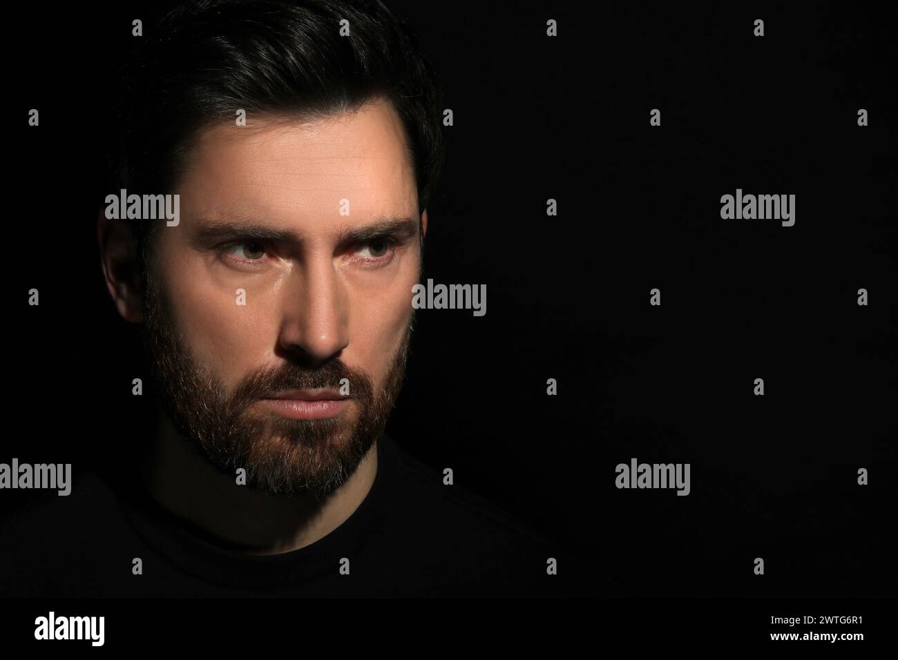 Evil eye. Man with scary eyes in darkness, space for text Stock Photo ...