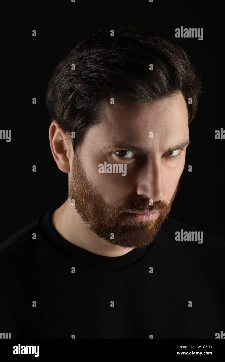 Evil eye. Man with scary eyes on black background Stock Photo - Alamy