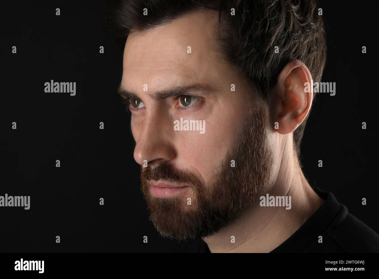 Evil eye. Man with scary eyes on black background, closeup Stock Photo ...