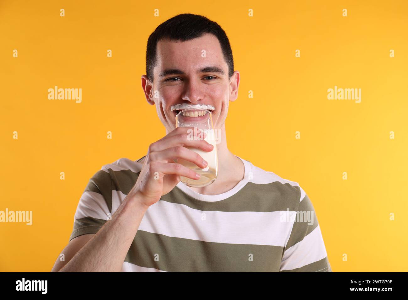 Milk mustache left after dairy product. Man drinking milk on orange background Stock Photo - Alamy