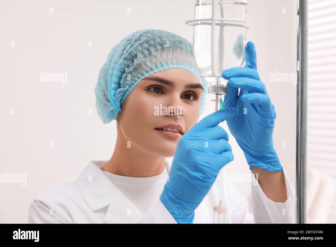 Nurse setting up IV drip in hospital Stock Photo - Alamy