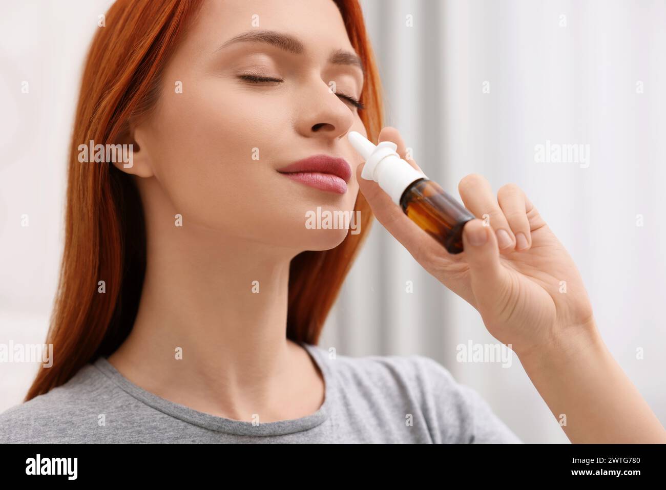 Medical drops. Woman using nasal spray at home Stock Photo - Alamy
