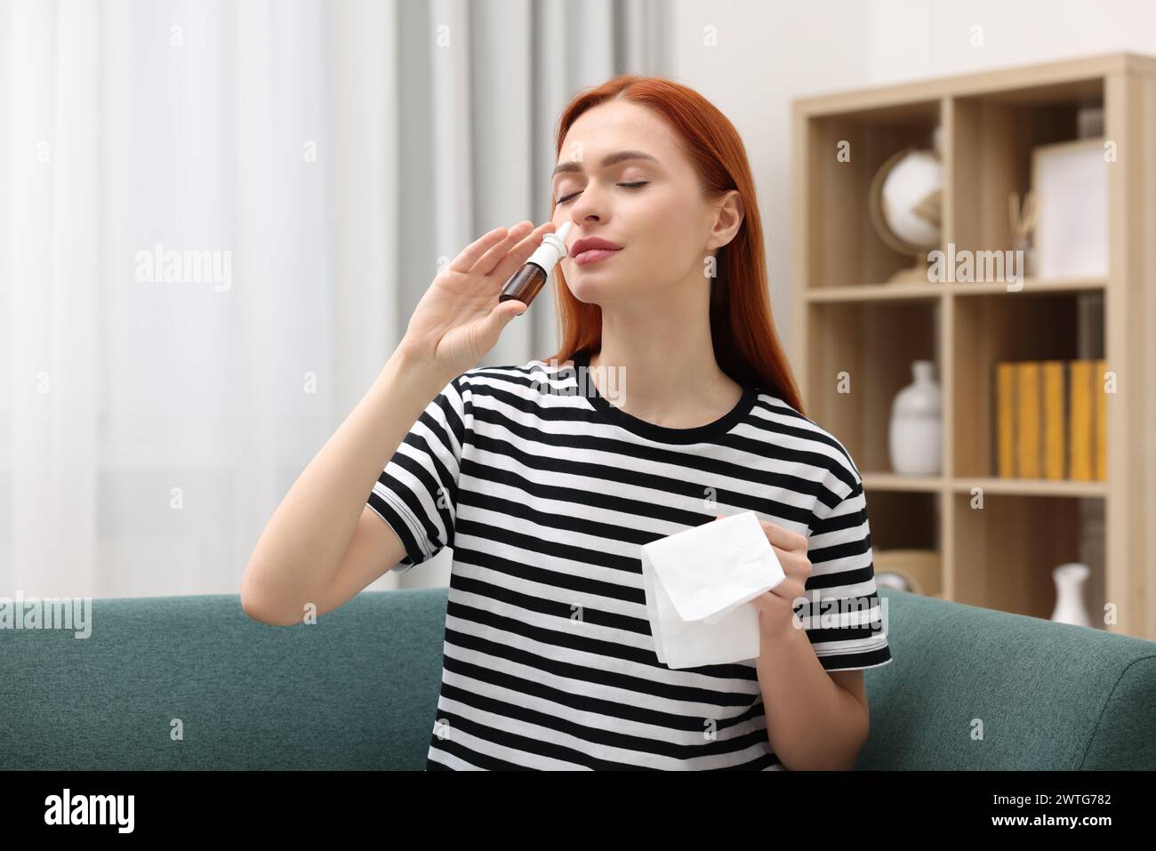 Medical drops. Woman with tissue using nasal spray at home Stock Photo ...